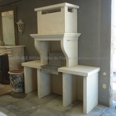 Beautiful stone barbecue with integrated fireplace and hood in stone.