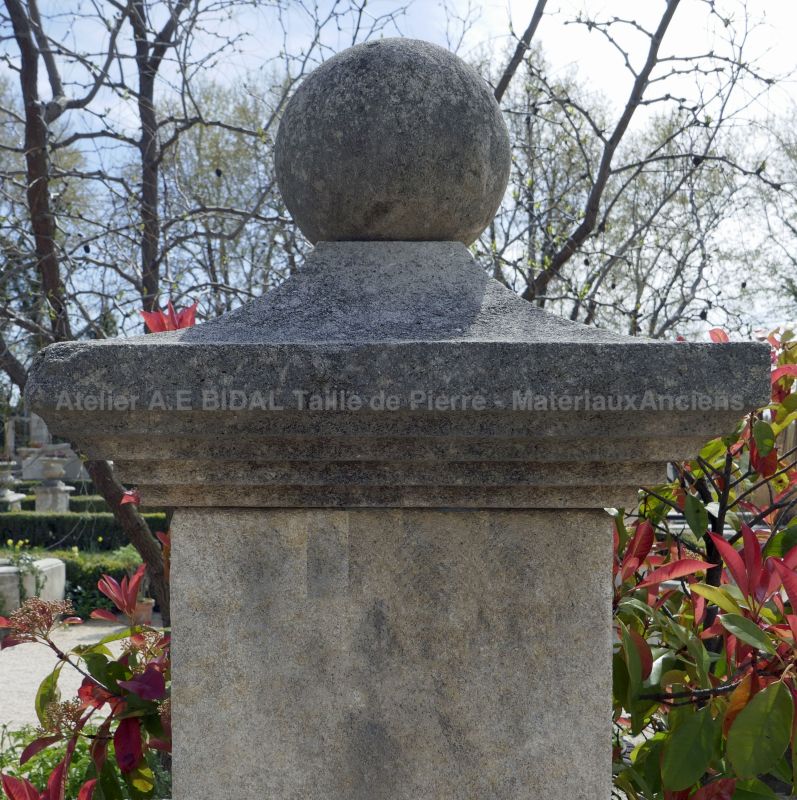 Pair of stone pillars - rectangular, with a ball on top.