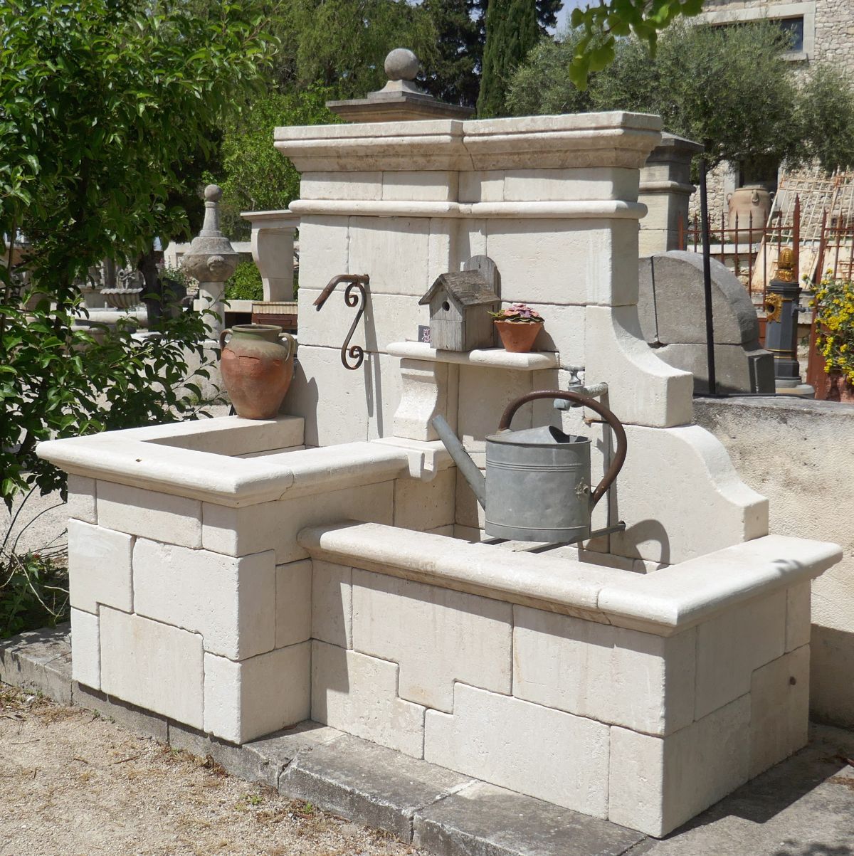 Rustic garden wall fountain by the stonemason Alain Bidal in Provence