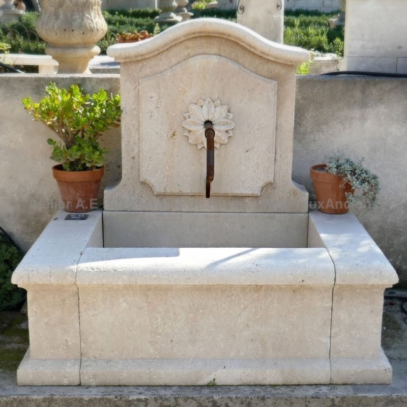 Small outdoor wall fountain in stone ǀ Garden fountain from Provence.