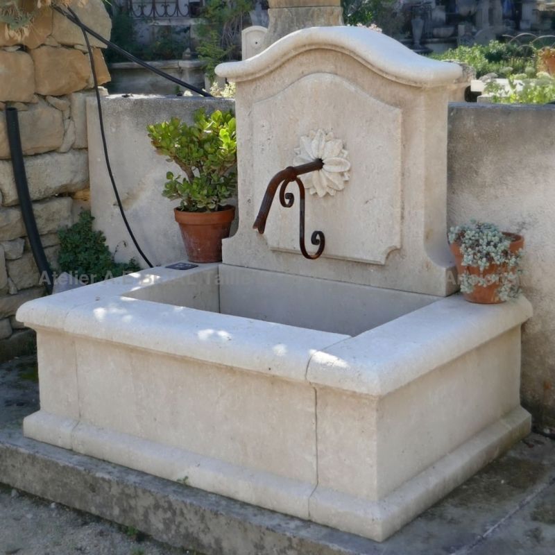 Small outdoor wall fountain in stone ǀ Garden fountain from Provence.