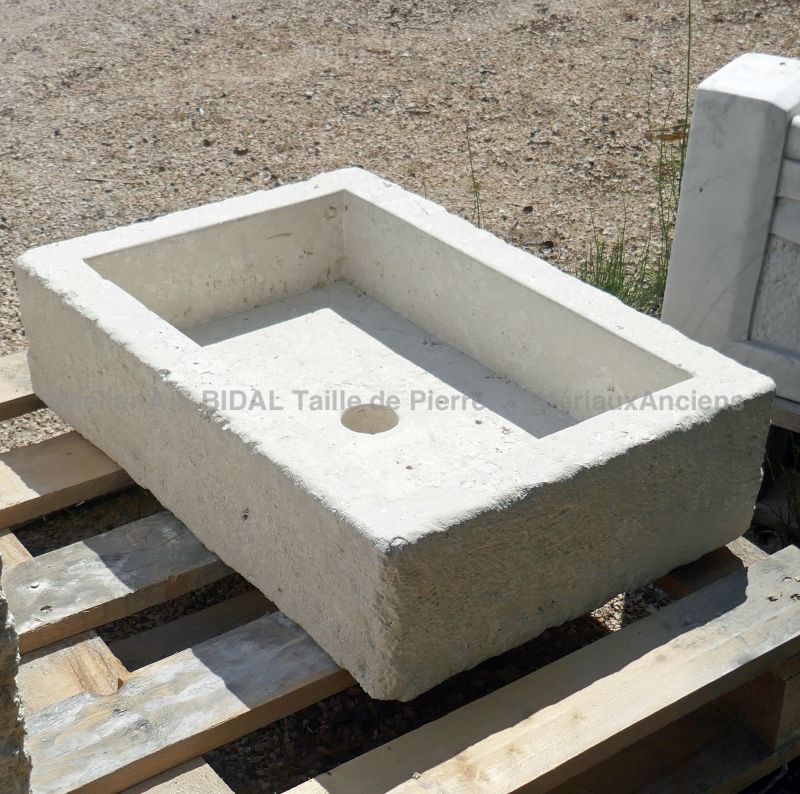 Small and shallow sink in white limestone for kitchen or bathroom